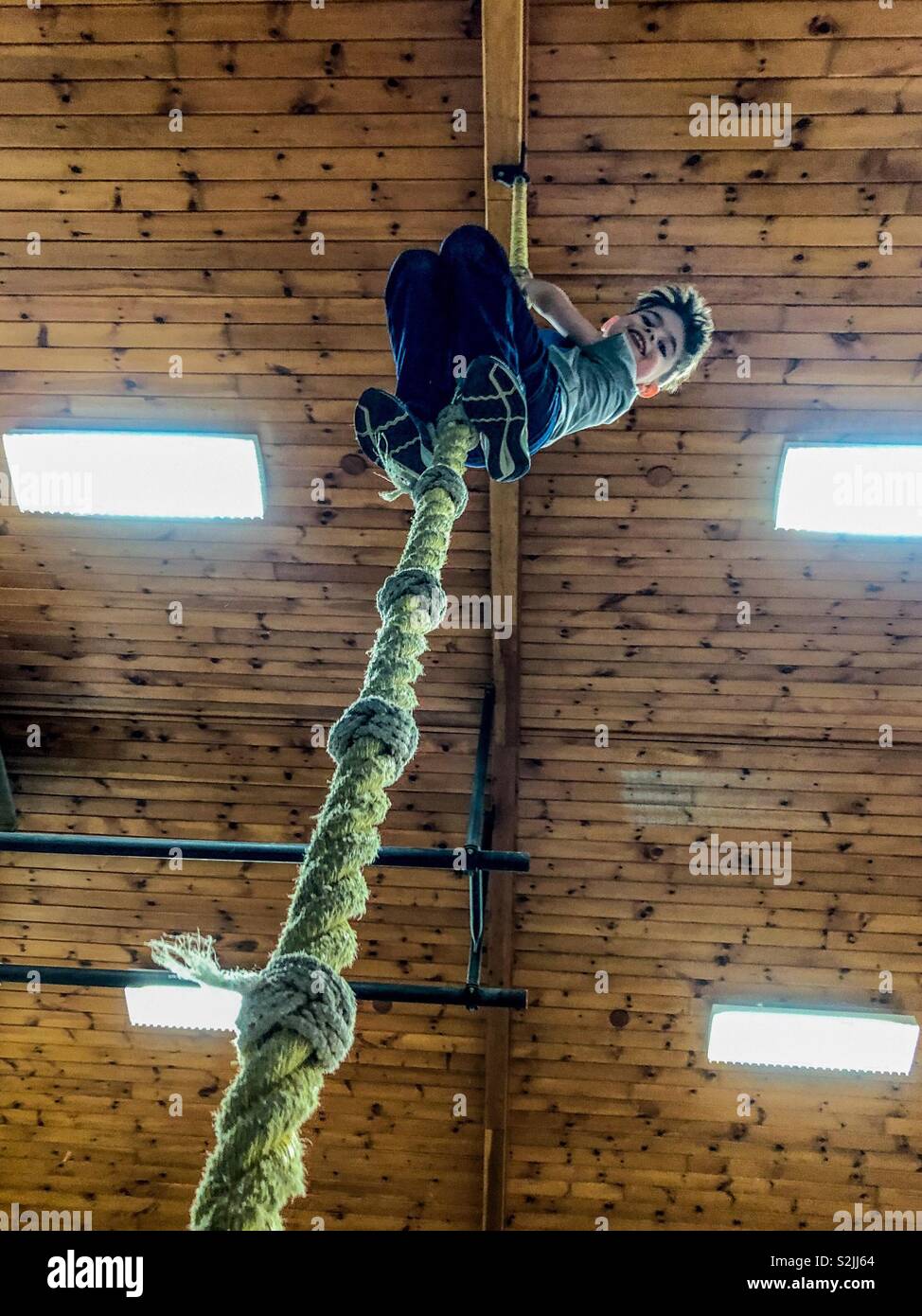 Climbing a rope in gym class hi-res stock photography and images - Alamy