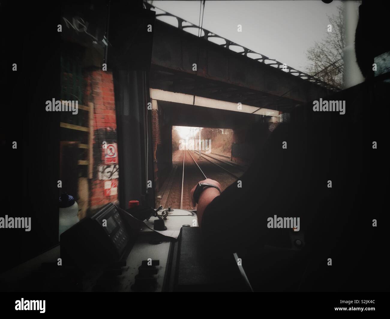 A view over the shoulder of a tram driver, looking down the line in ...
