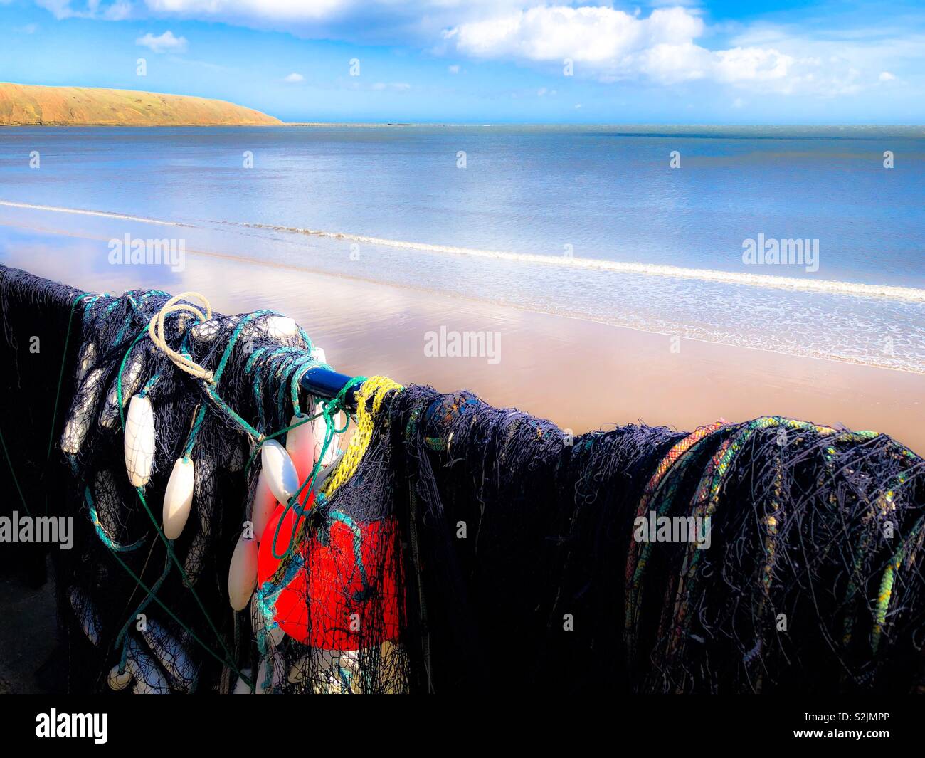 Fishing gear drying in the sun beside a beach Stock Photo - Alamy