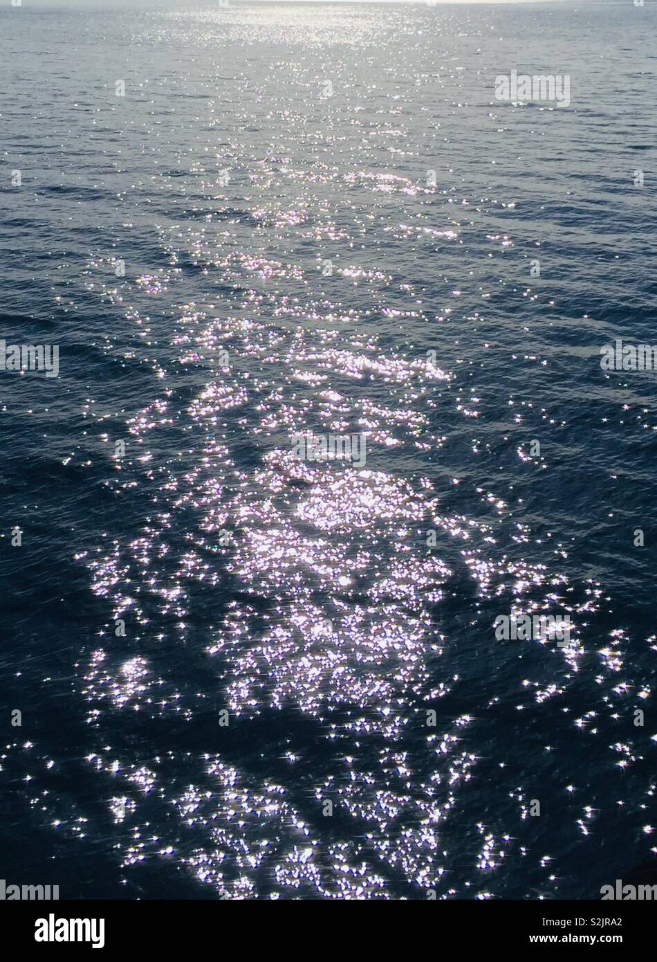 Sun reflecting on sea Stock Photo - Alamy