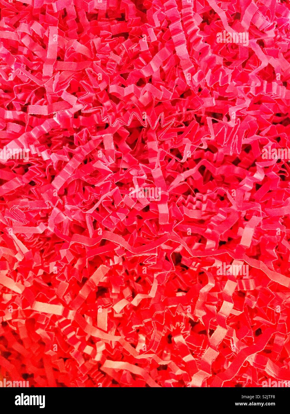 Tons of red paper string confetti filling up the frame Stock Photo - Alamy
