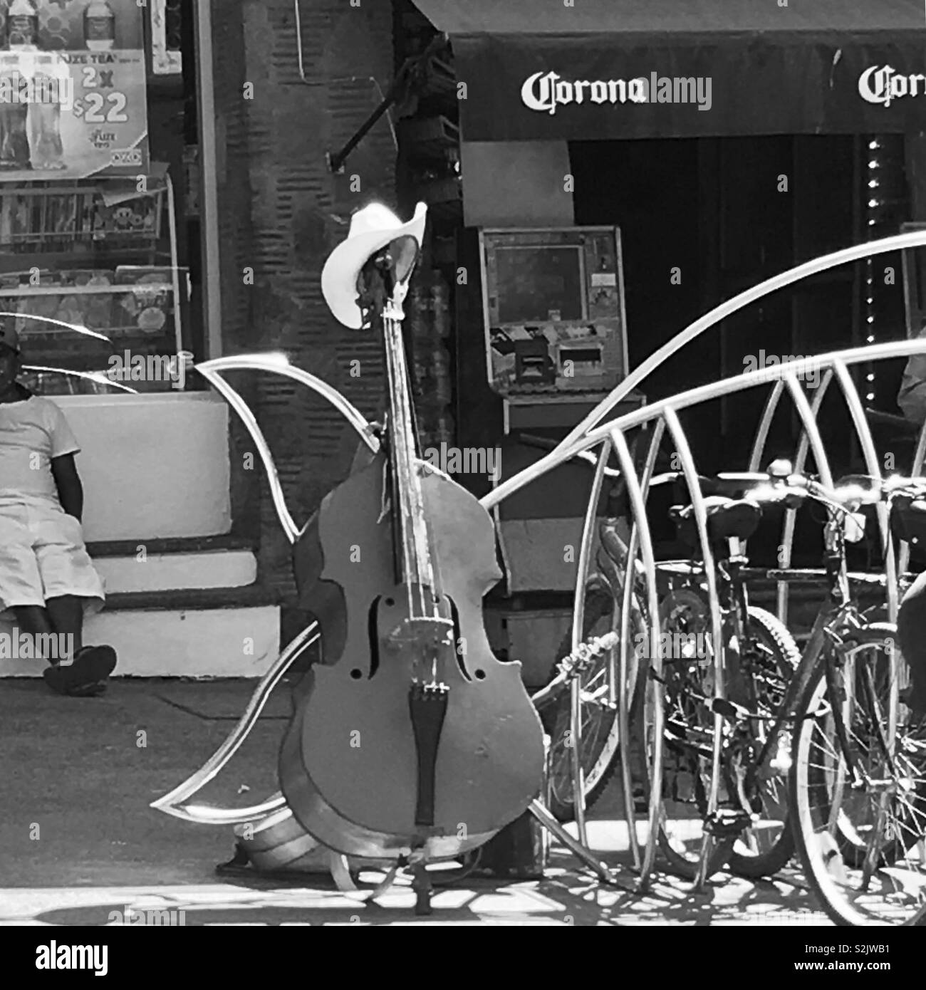 Street art, performer’s instrument, bass, rests against bike rack Stock ...