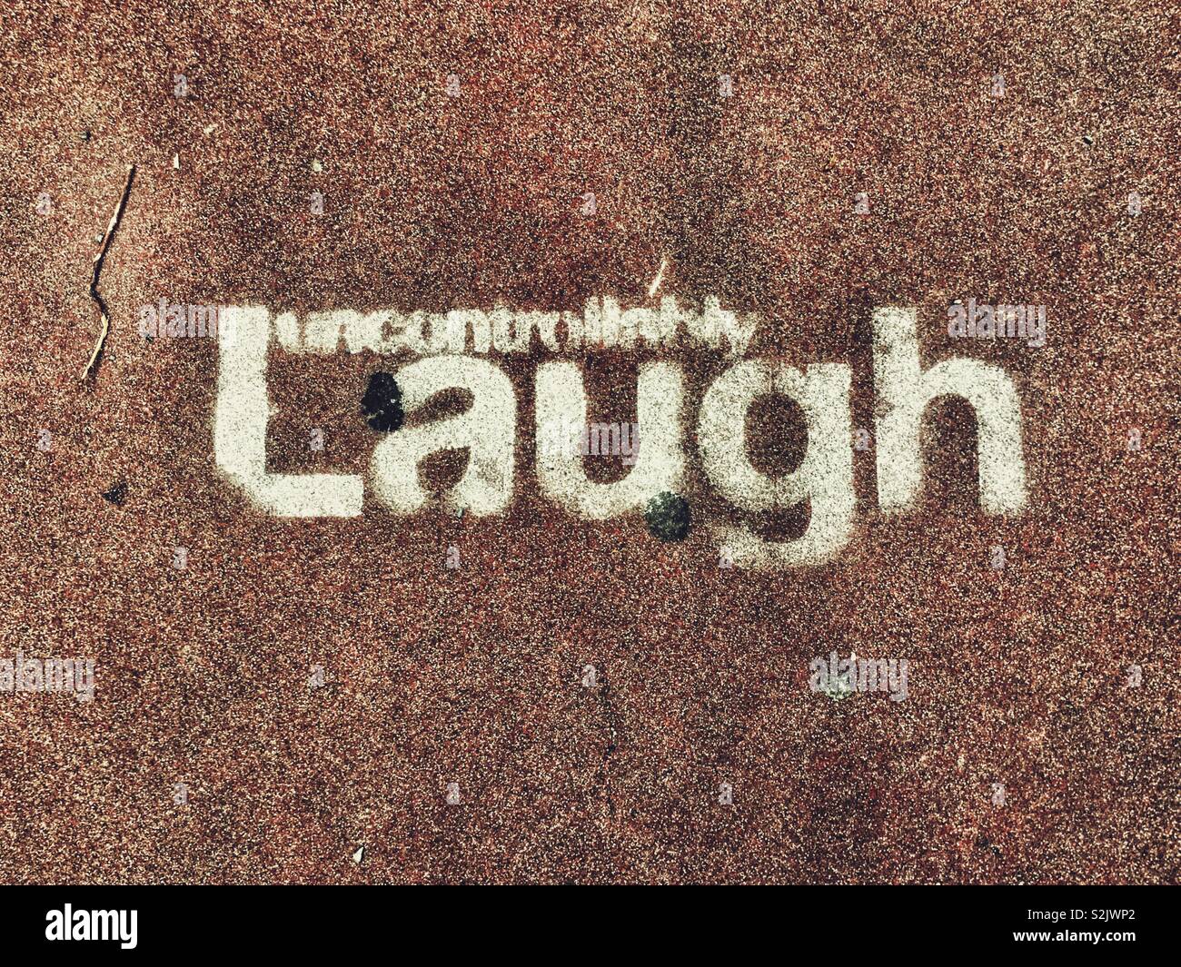 Positive pavement slogan Stock Photo - Alamy