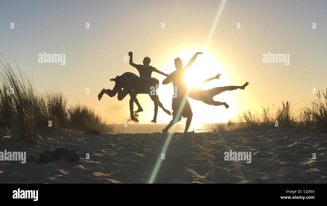 Sun jumping silhouette Stock Photo - Alamy