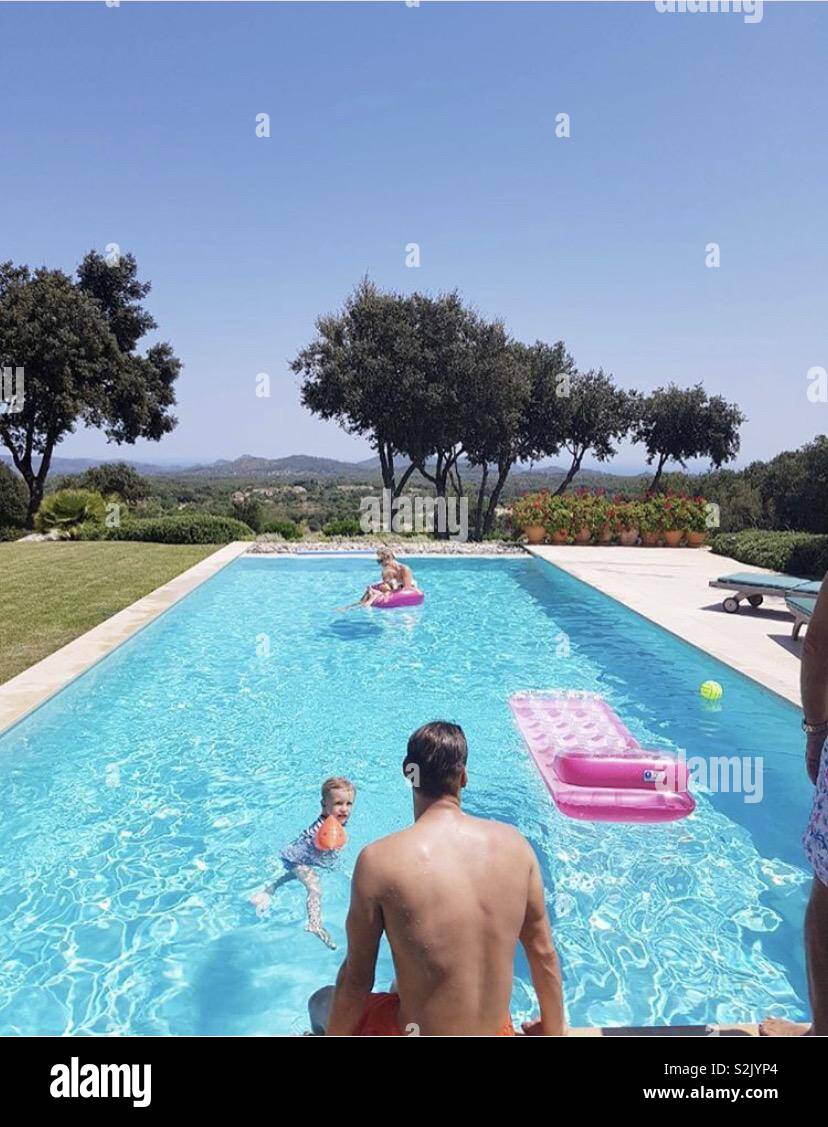 Family by the swimming pool Stock Photo - Alamy