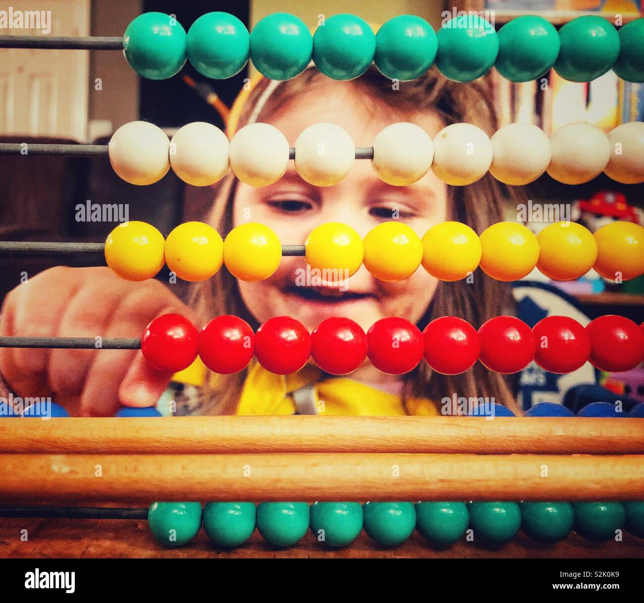 Young child counting with abacus Stock Photo - Alamy