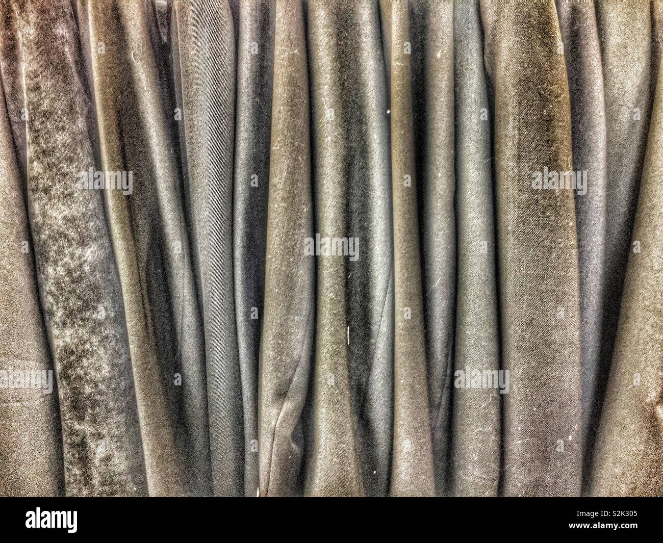 Various gray fabrics hanging from a rod and on display Stock Photo - Alamy