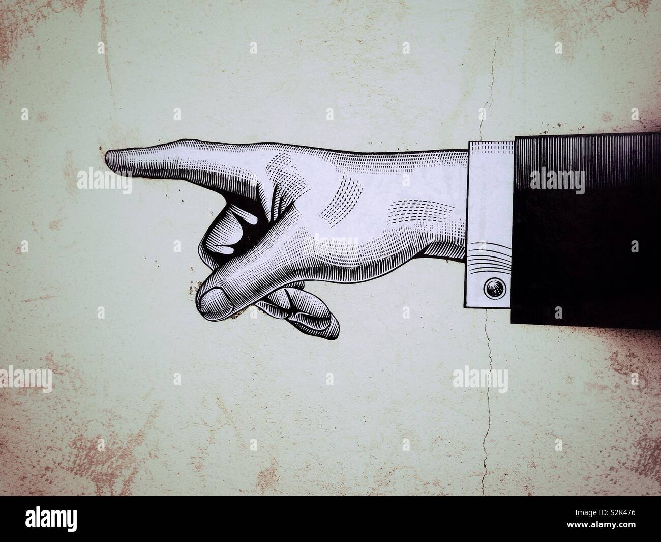 Pointing finger direction sign painted on a plaster wall Stock Photo ...