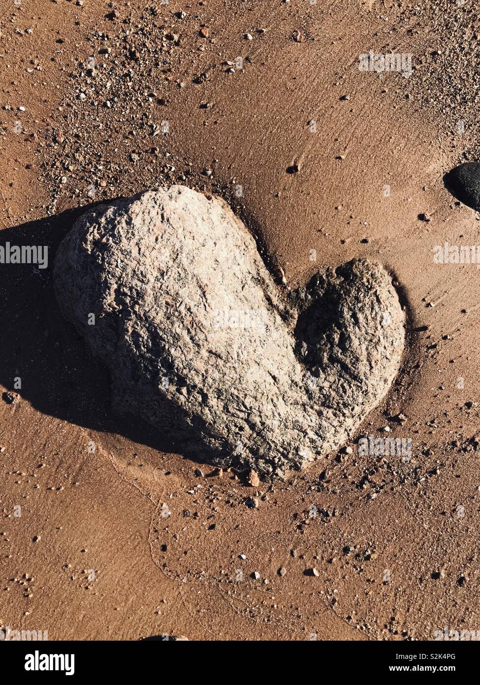 LOVE. Stone heart on the beach. Sunny find at the Baltic seaside Stock ...