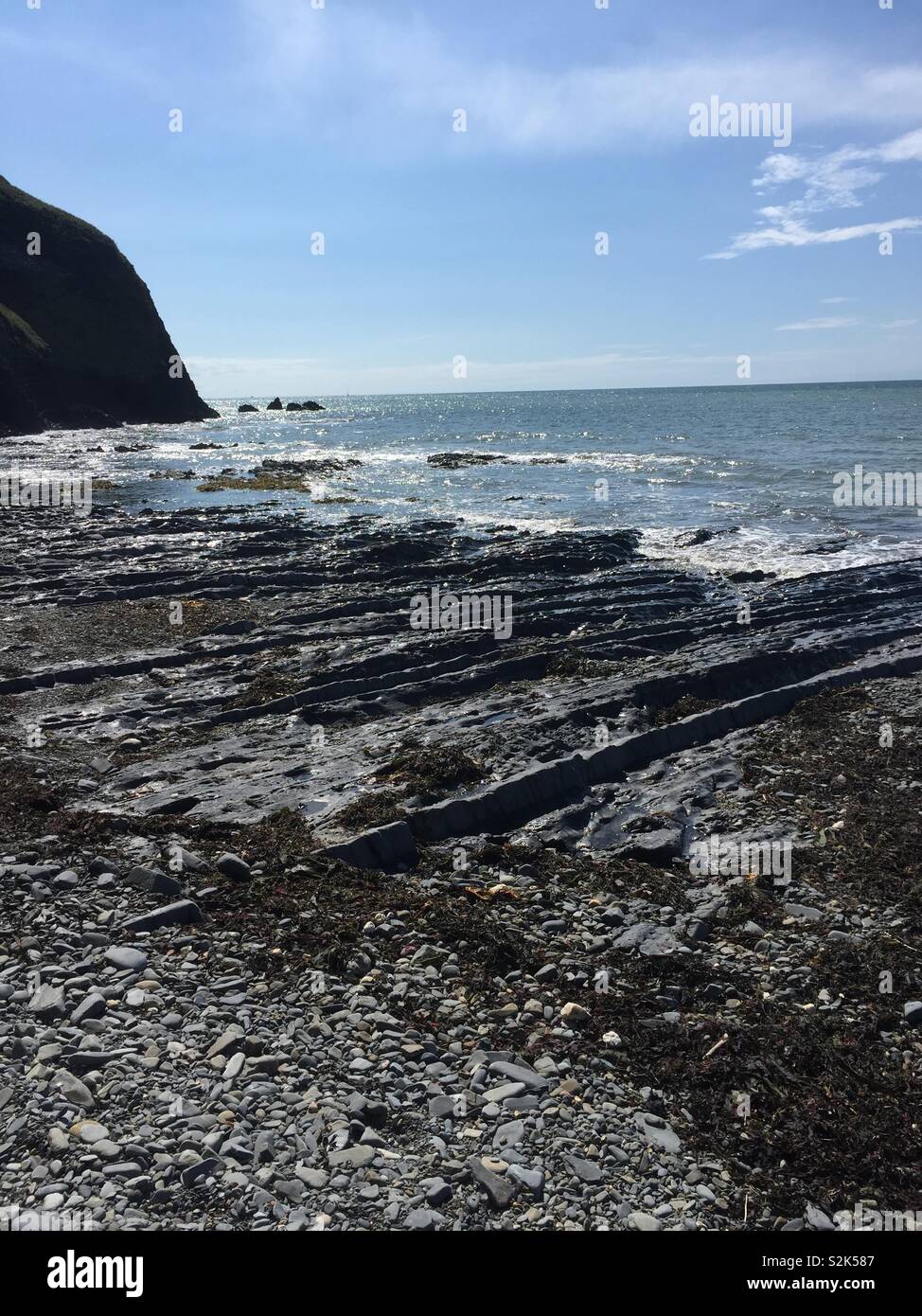 Rockery on the beach Stock Photo - Alamy