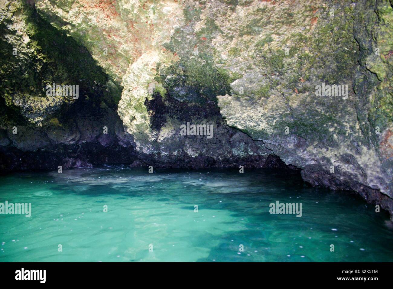 View into a Cave with a fascinating play of colors, turquoise-seeming ...