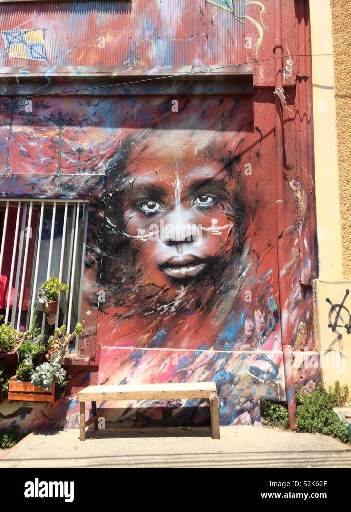 Striking face mural on the streets of Valparaiso, Chile Stock Photo - Alamy