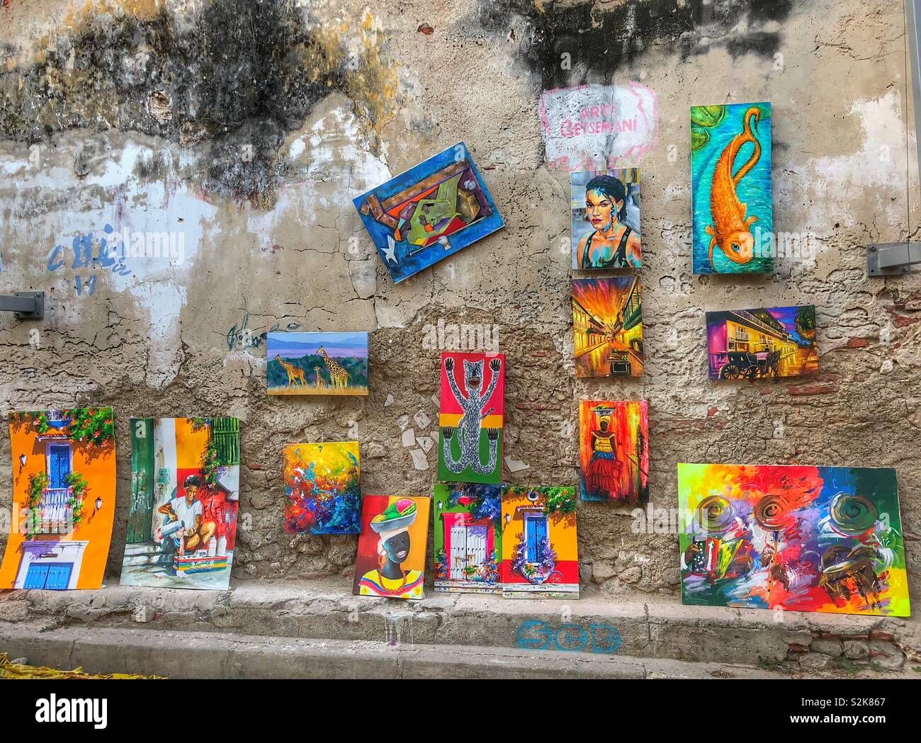 A wall display of local paintings in the Getsemani neighbourhood in ...