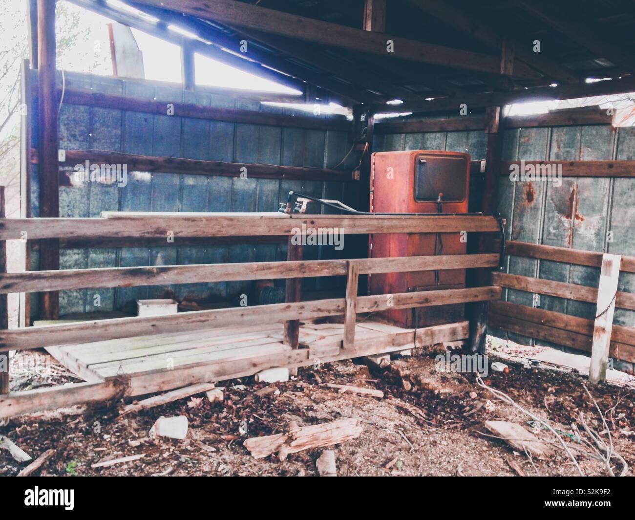 Old rusted refrigerator on a wooden platform inside a barn Stock Photo ...