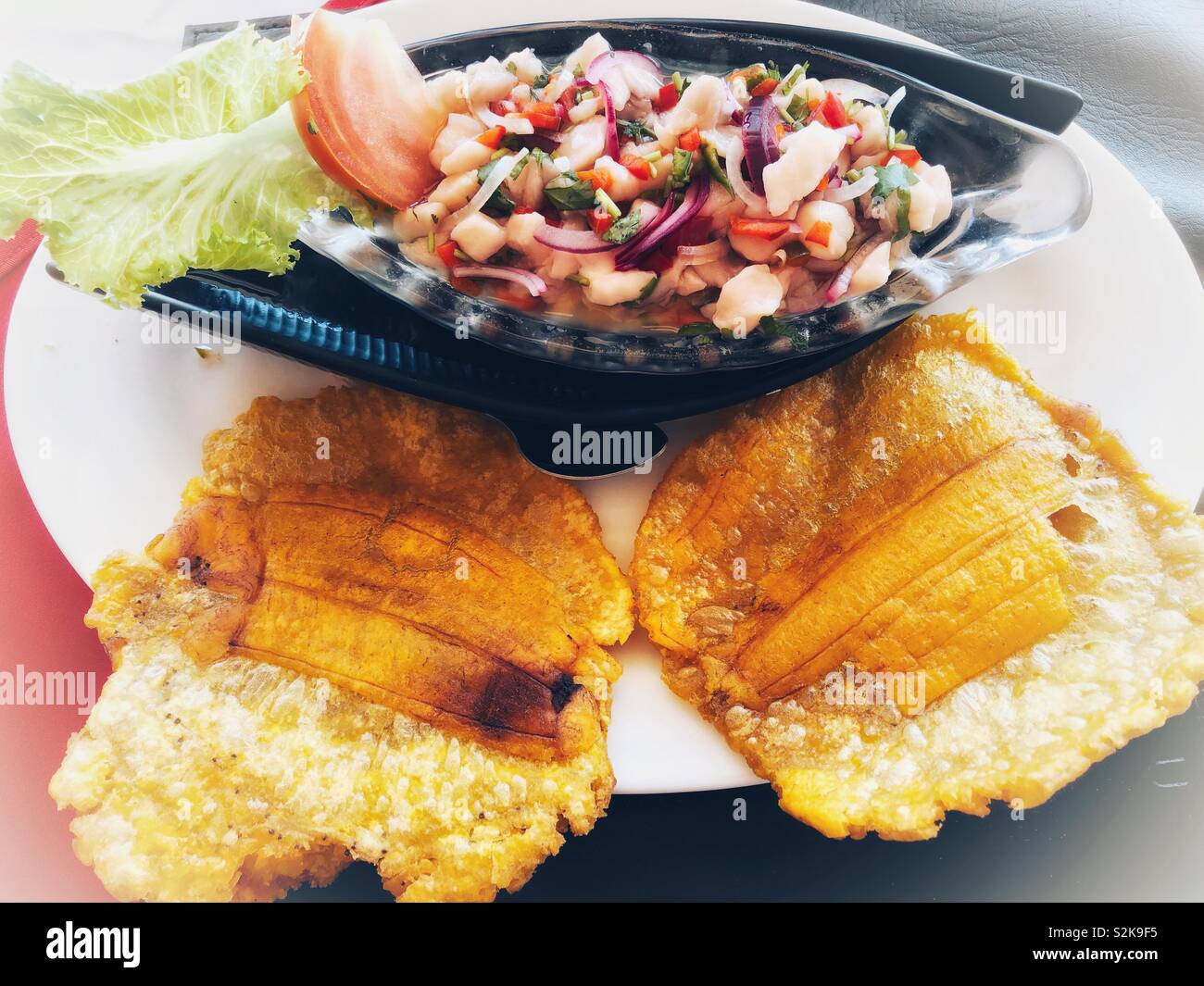 A serving of ceviche and patacones Stock Photo - Alamy