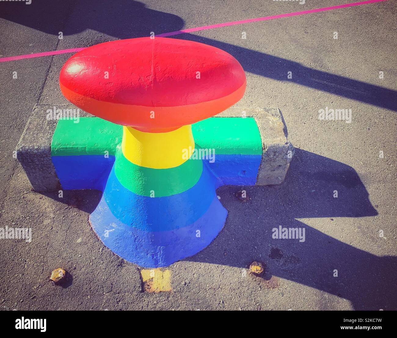 Rainbow bollard on a dock Stock Photo - Alamy