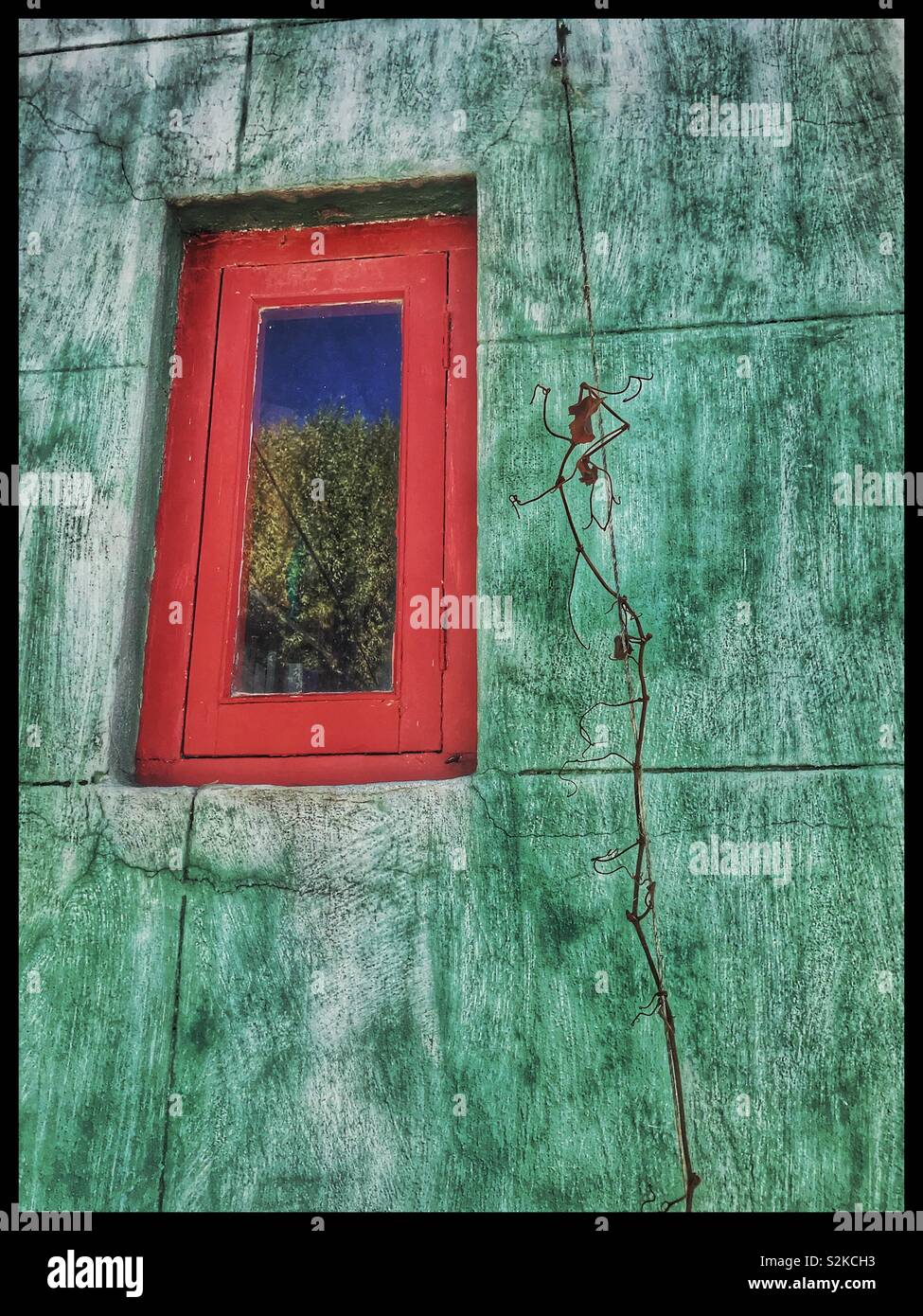 Reflection of tree in window with red frame Stock Photo - Alamy