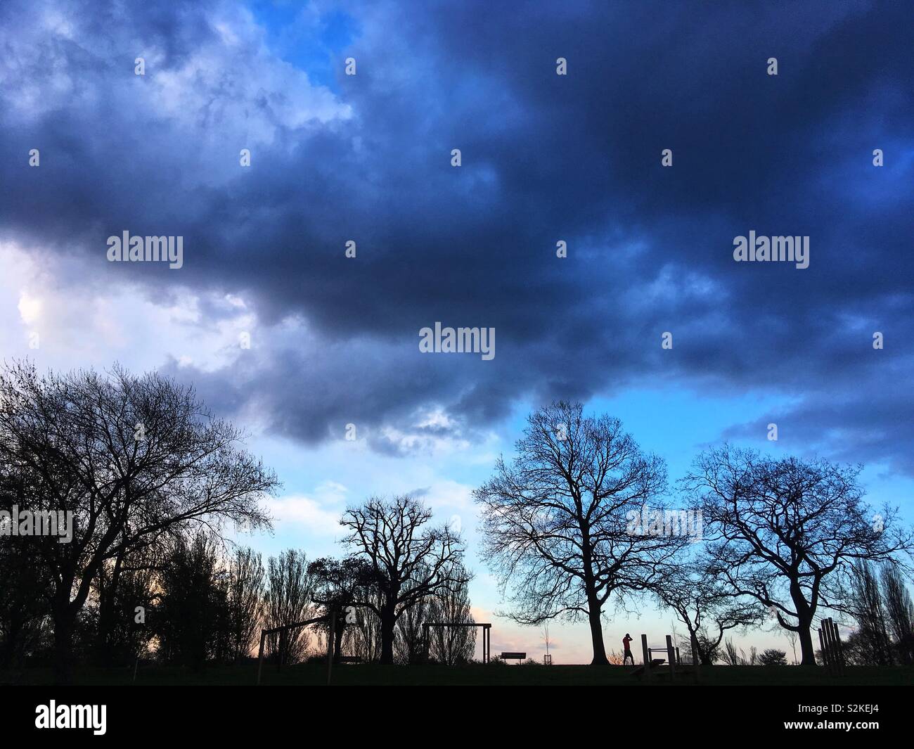 Moody sky in a park in London, England Stock Photo - Alamy