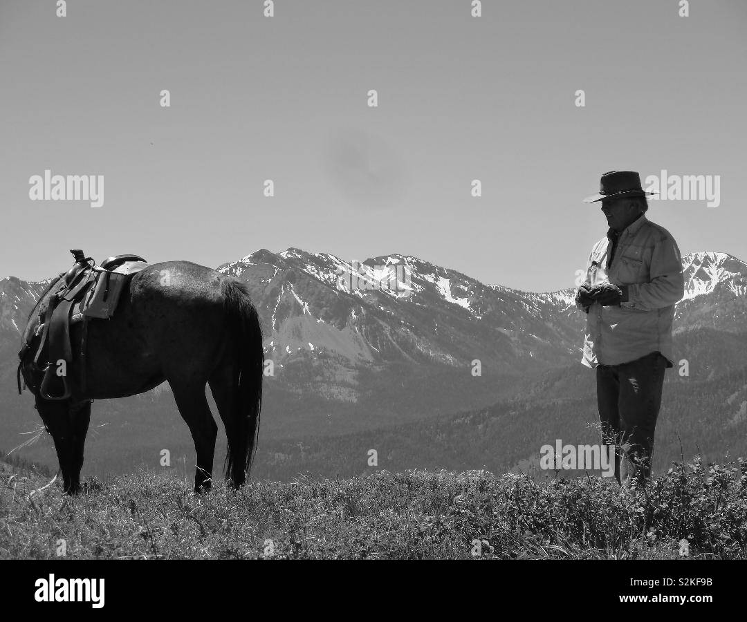 A Wyoming rancher taking a break from a trail ride in the grand Teton ...