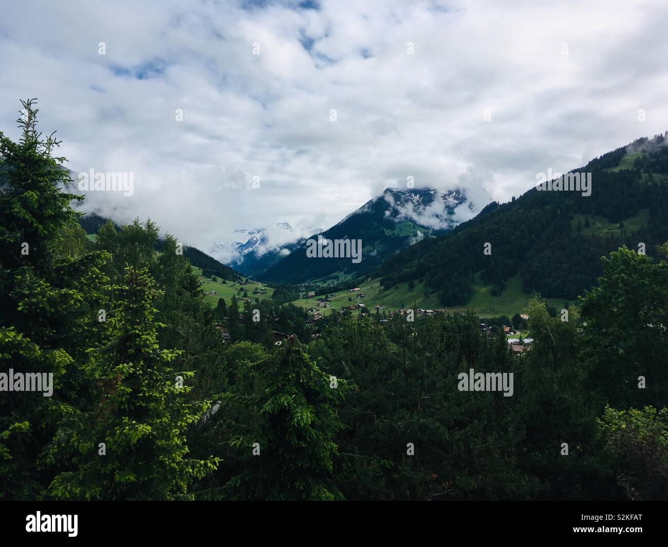 Landscape of mountains and cottages; Gstaad; Switzerland Stock Photo ...