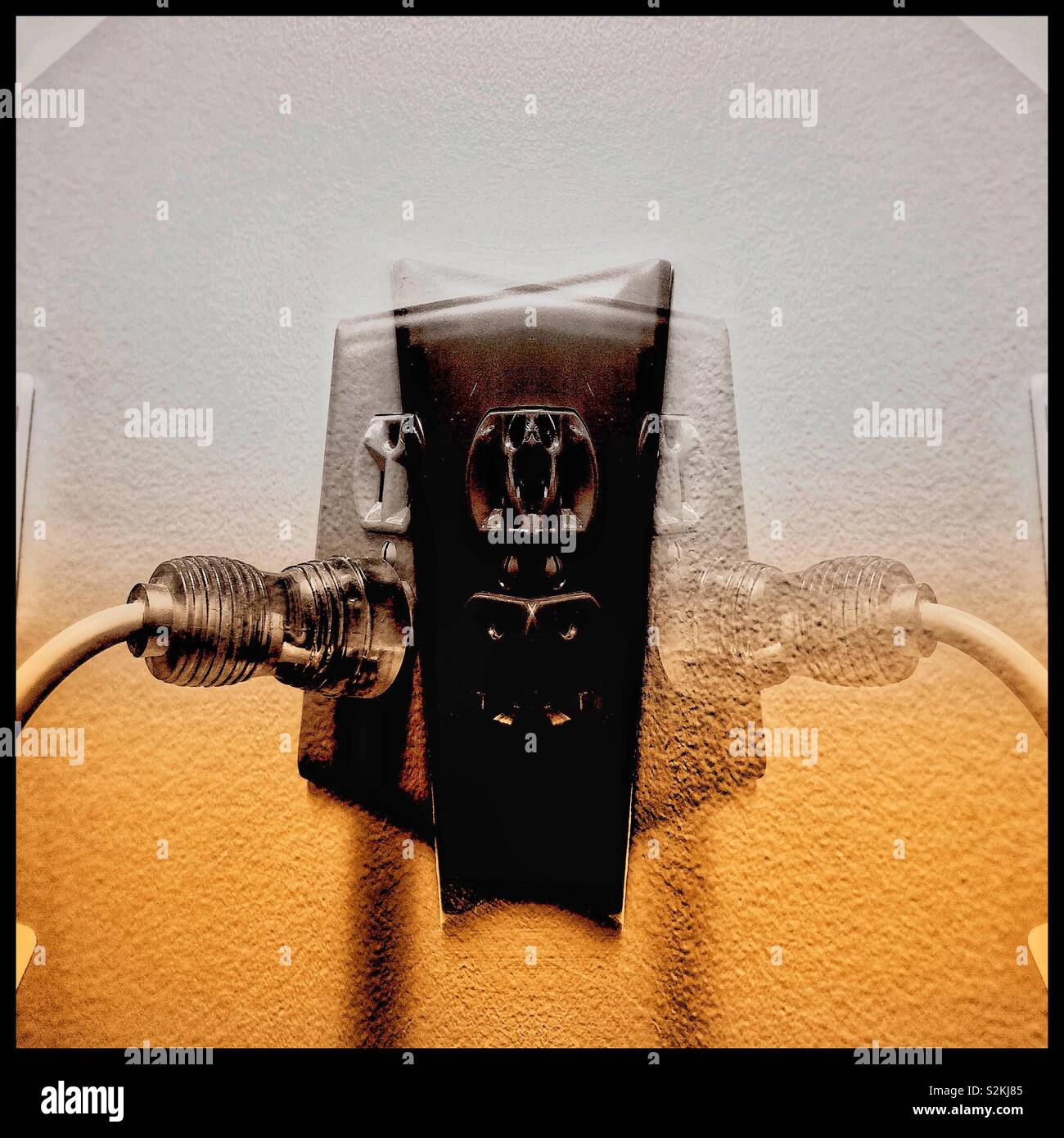 Wall socket with a plug in Stock Photo - Alamy