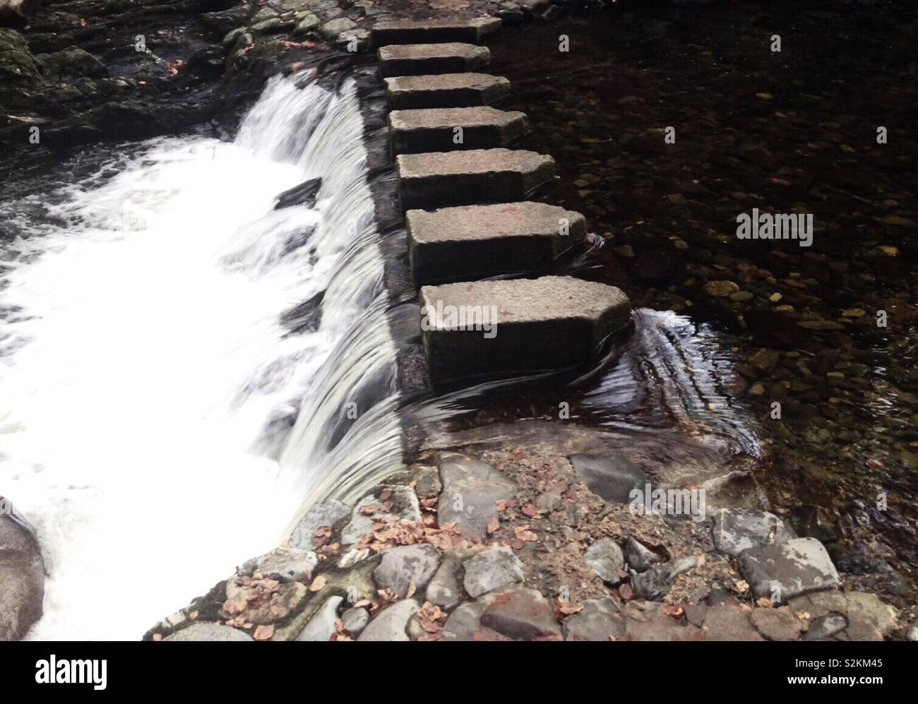 Water pouring down from stepping stones Stock Photo - Alamy