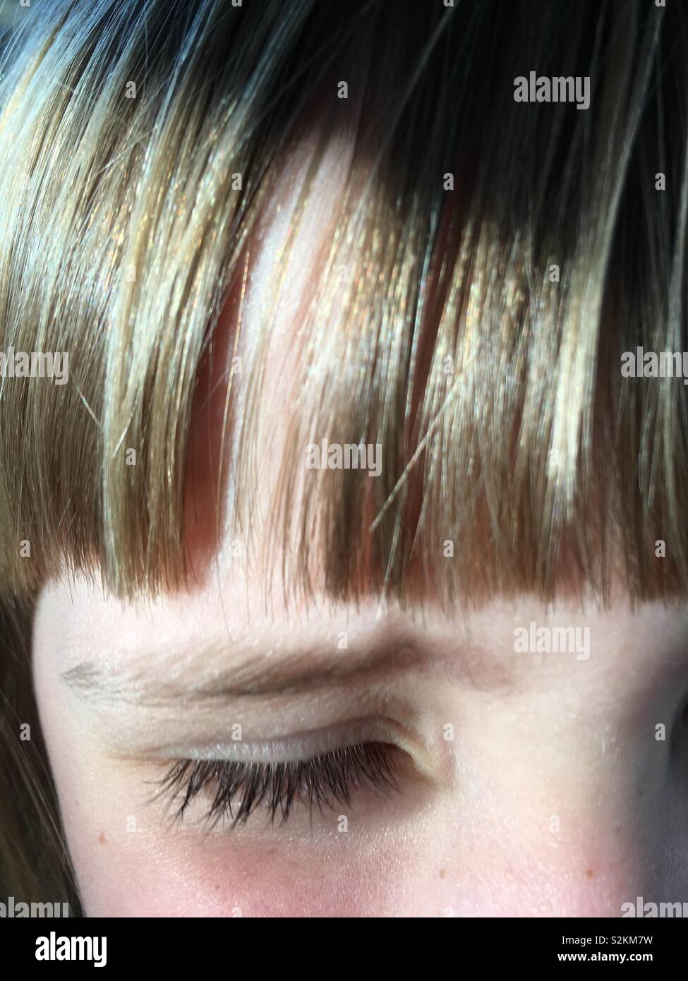 Girls fringe with closed eye Stock Photo - Alamy