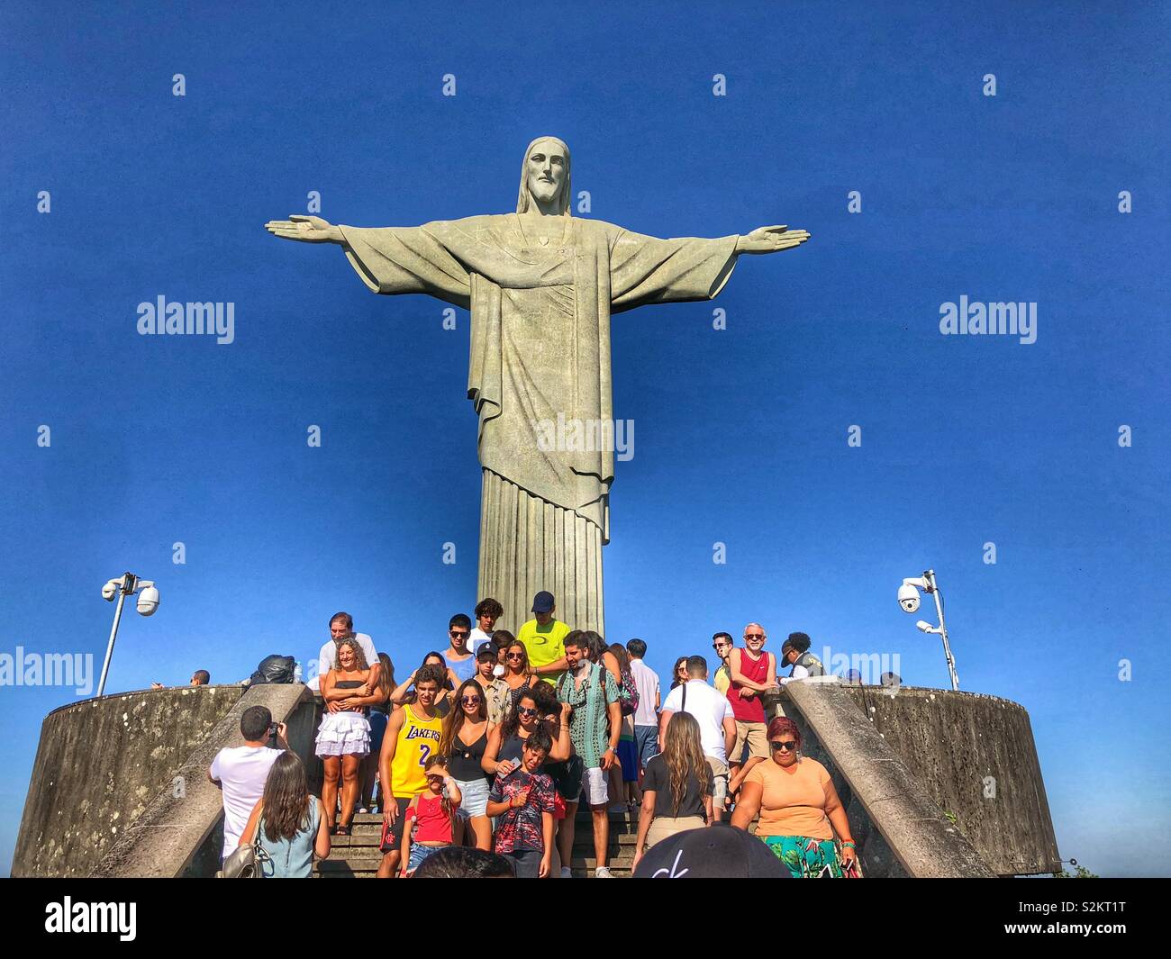 Tourists on the steps in front of the iconic Christ the Redeemer statue ...