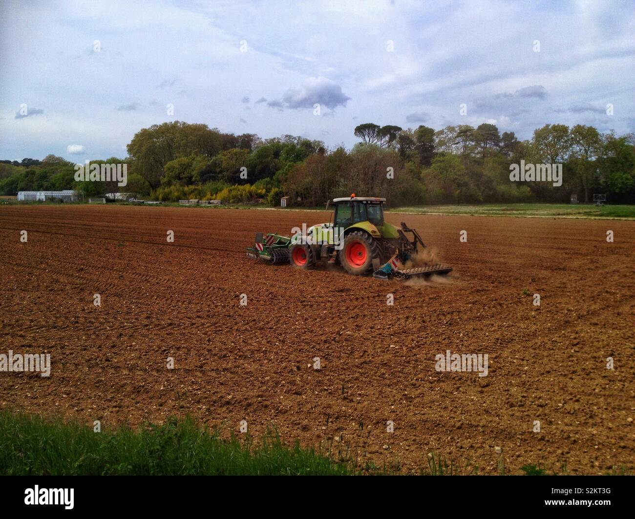 Tractor, soil preparation before planting Stock Photo - Alamy
