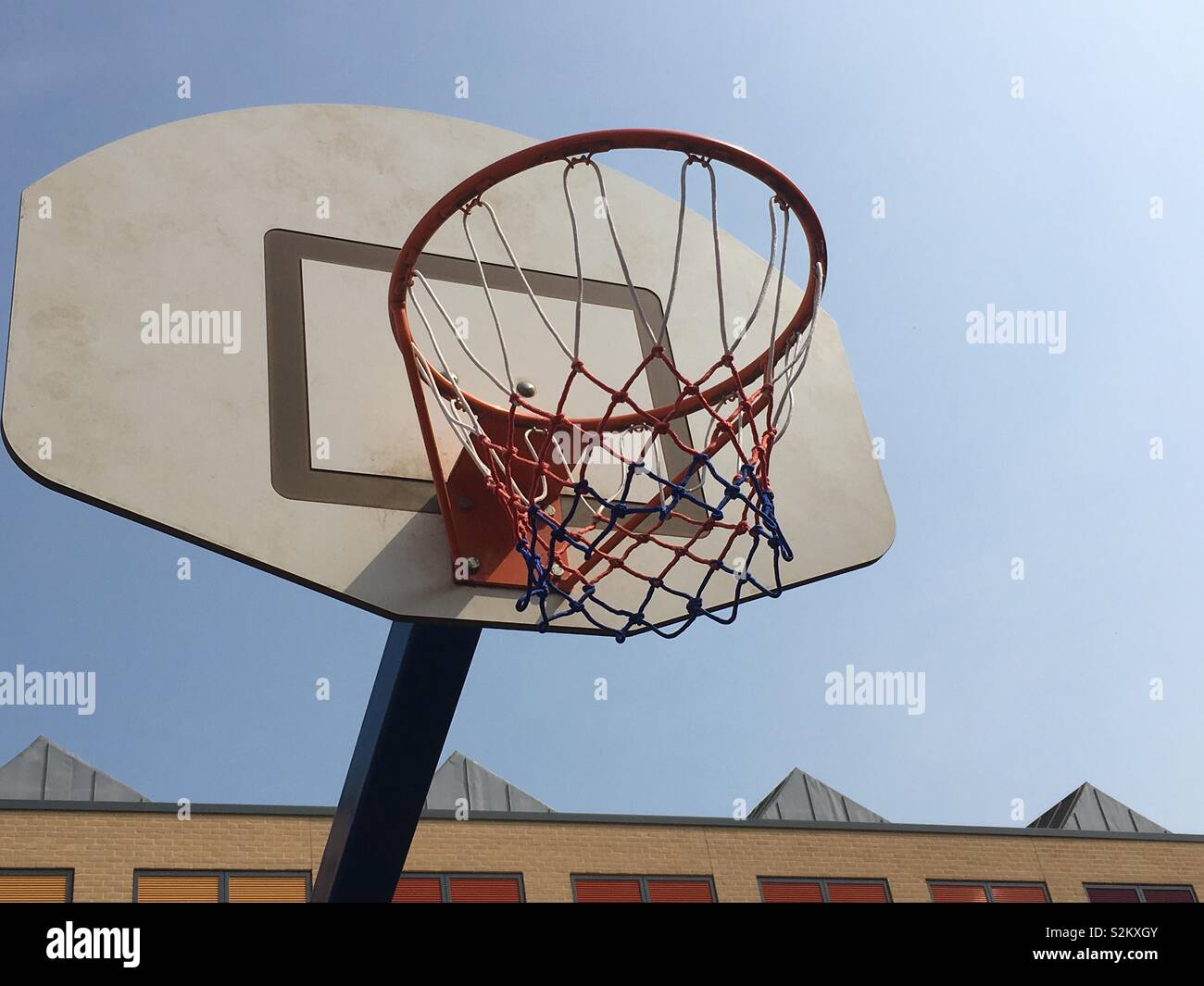 Basketball hoop with blue sky background Stock Photo - Alamy