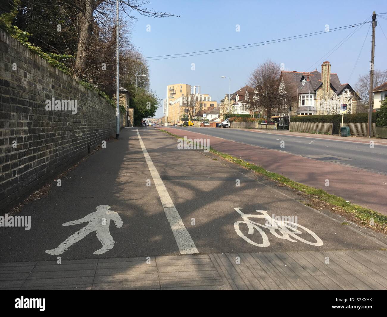 Walking and cycle lanes beside a city road Stock Photo - Alamy