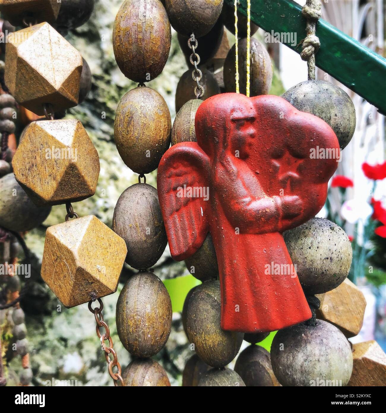 Rosary beads and angel figure at a catholic shrine Stock Photo - Alamy
