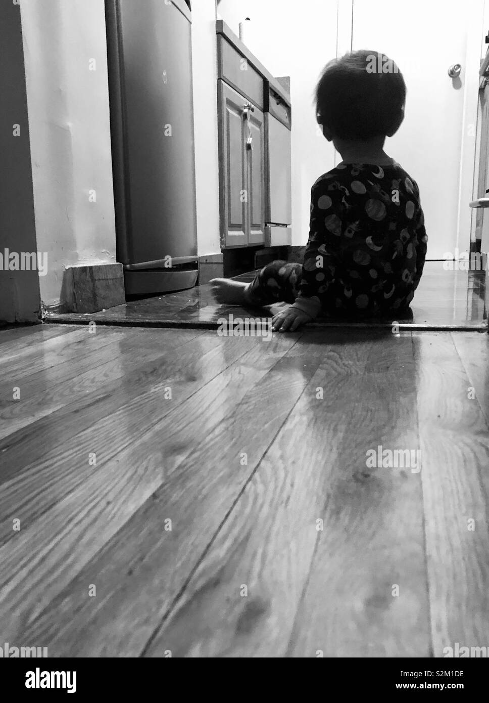 Child sitting on floor Stock Photo - Alamy