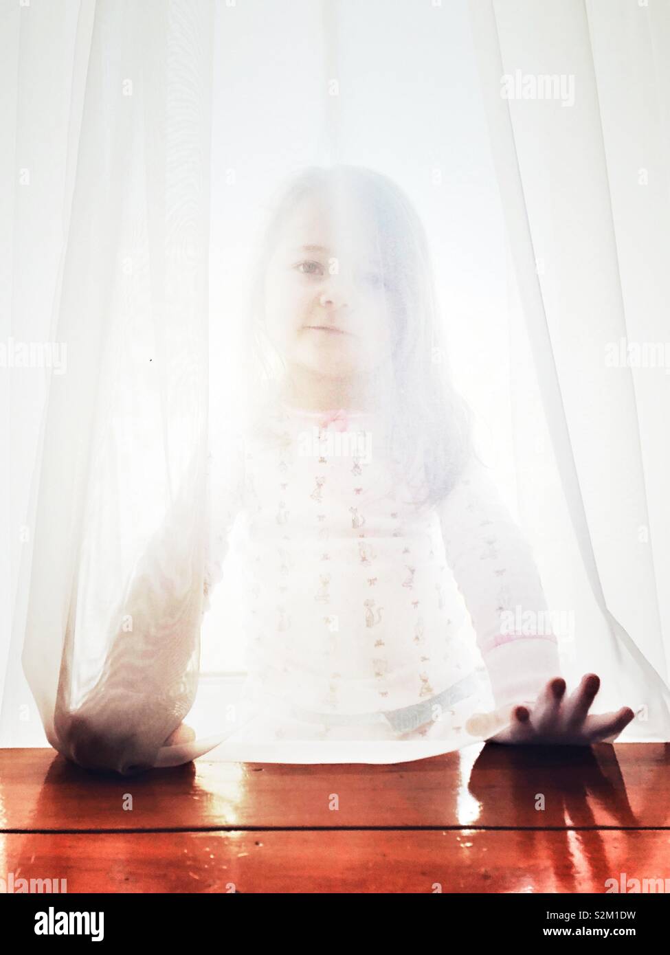 Child hiding behind curtain hi-res stock photography and images - Alamy