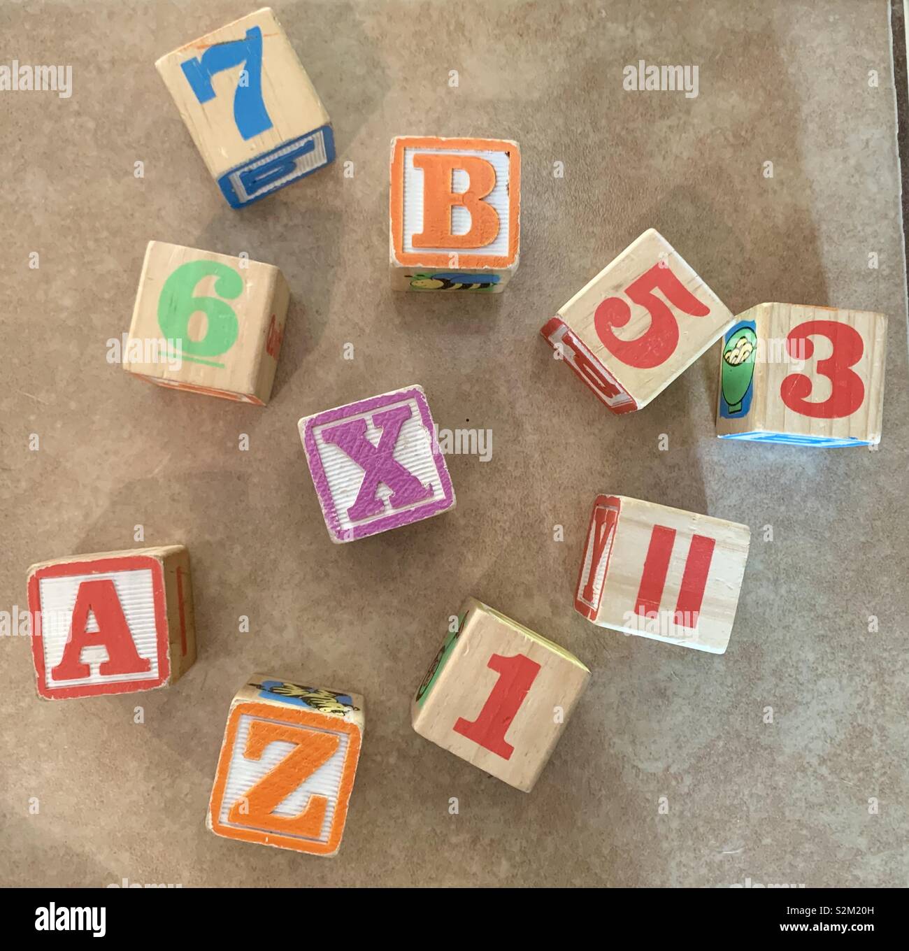 Colorful flat lay of children’s learning blocks with letters and ...