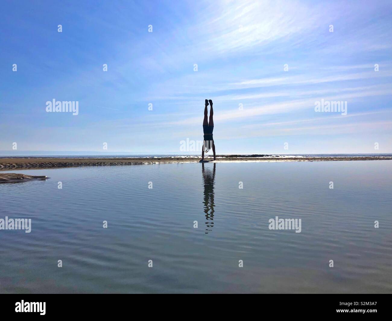 Woman doing handstand beach hi-res stock photography and images - Alamy