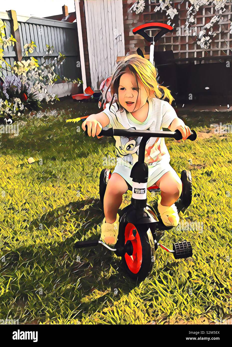 Girl on trike in the sunshine Stock Photo - Alamy