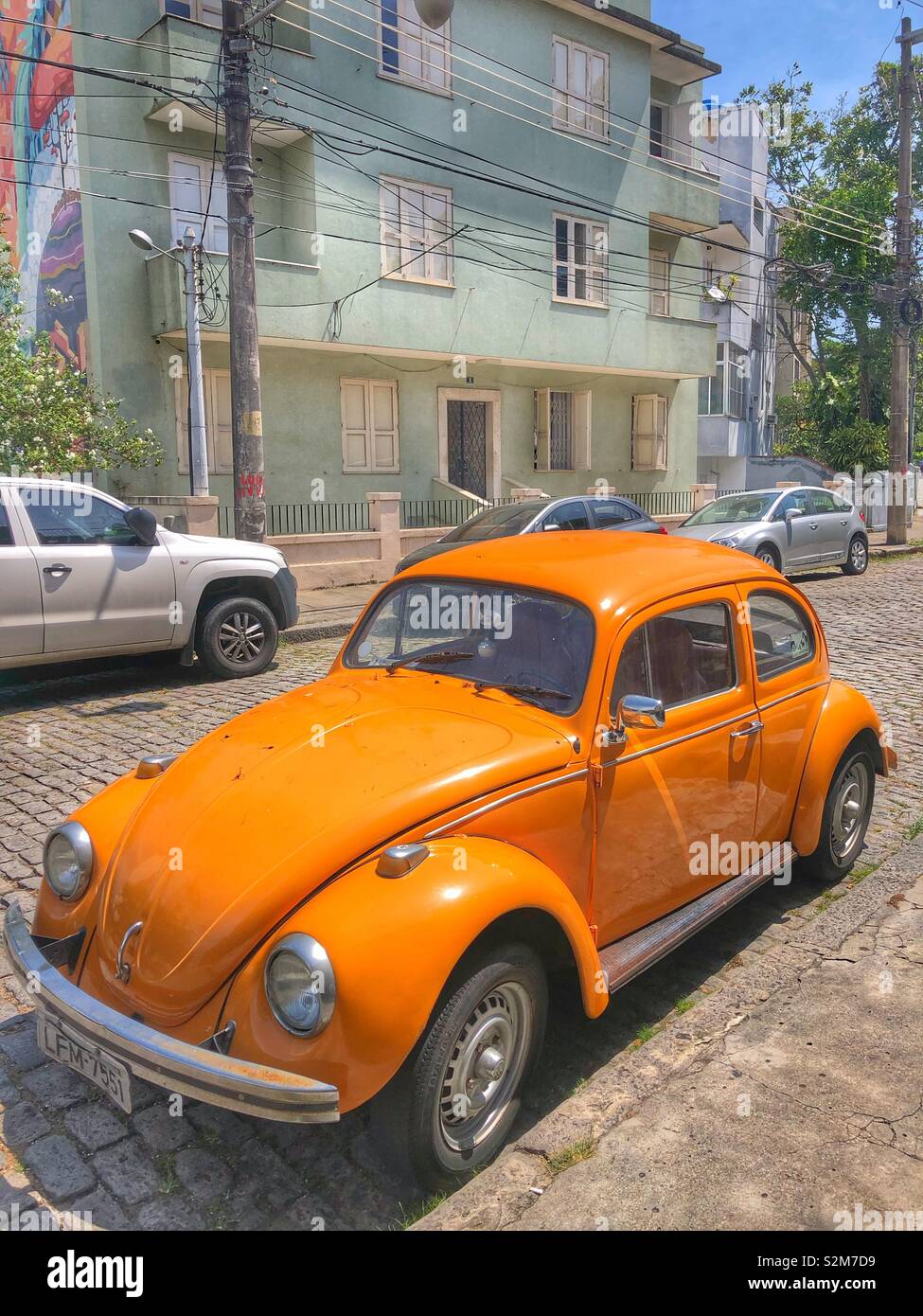 An orange vintage VW beetle bug parked on a street in Rio de Janeiro ...