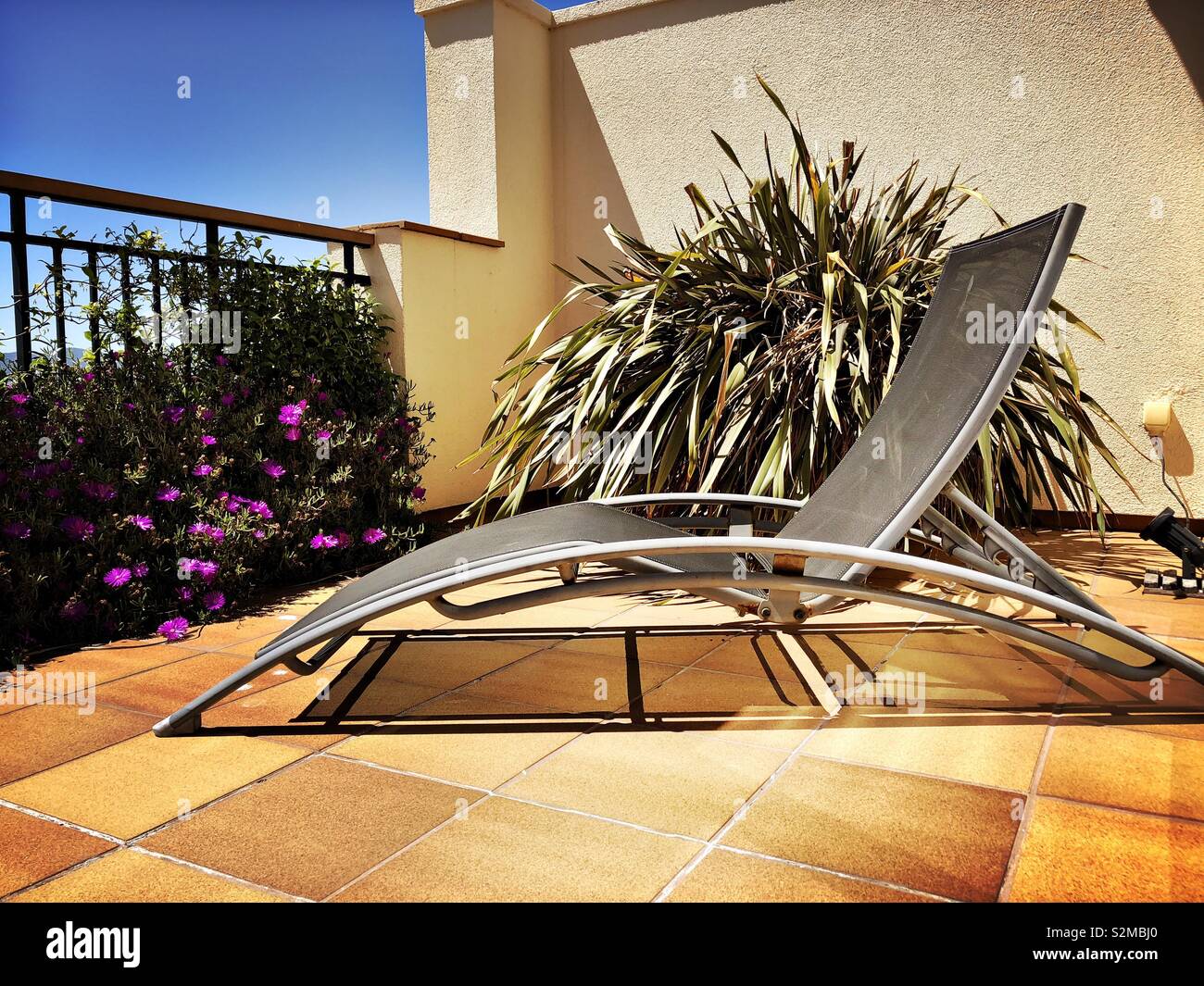 Sun lounger on terrace Stock Photo - Alamy