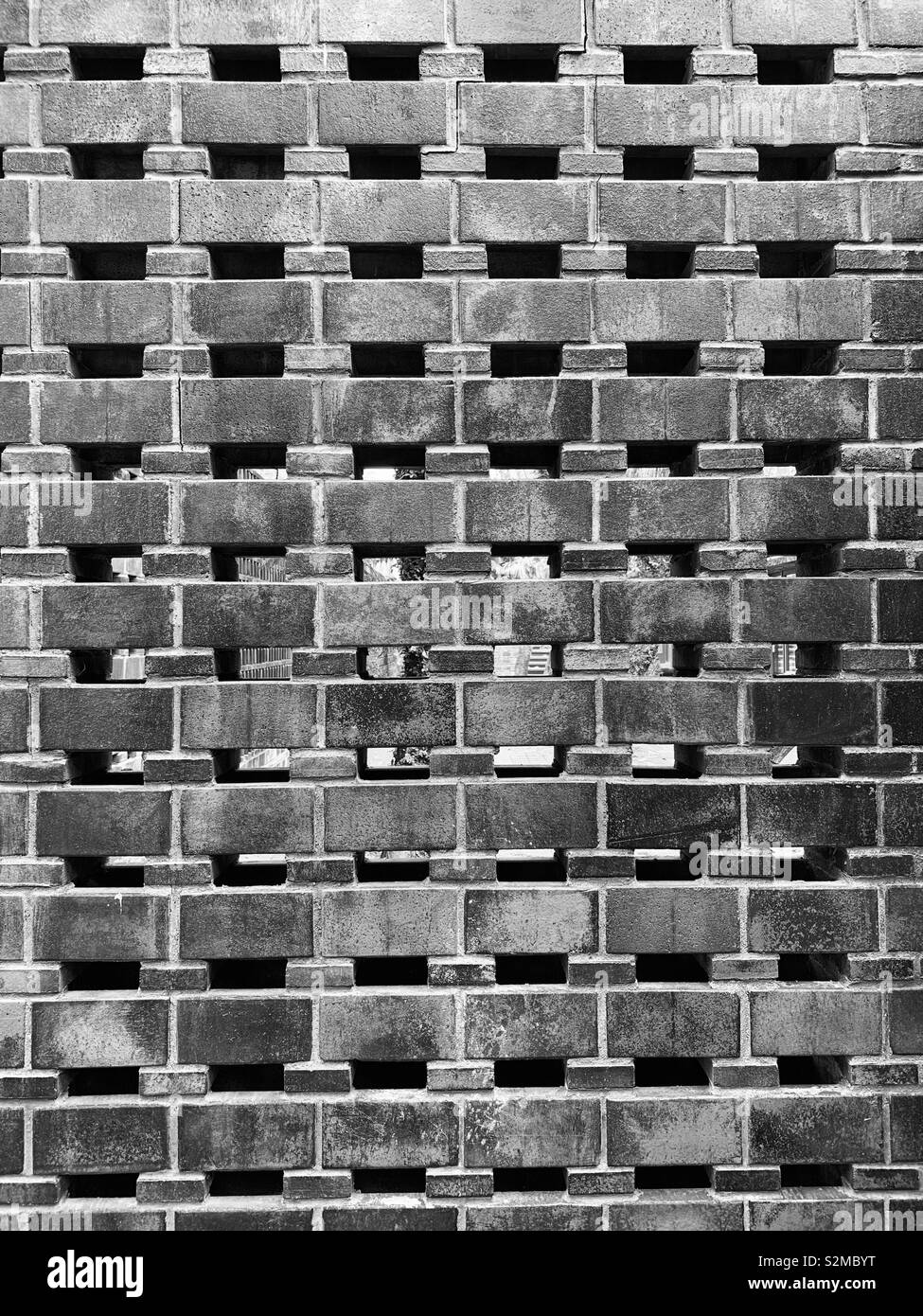 A brick-layered wall with matrix design of holes. Shot in Shenzhen ...