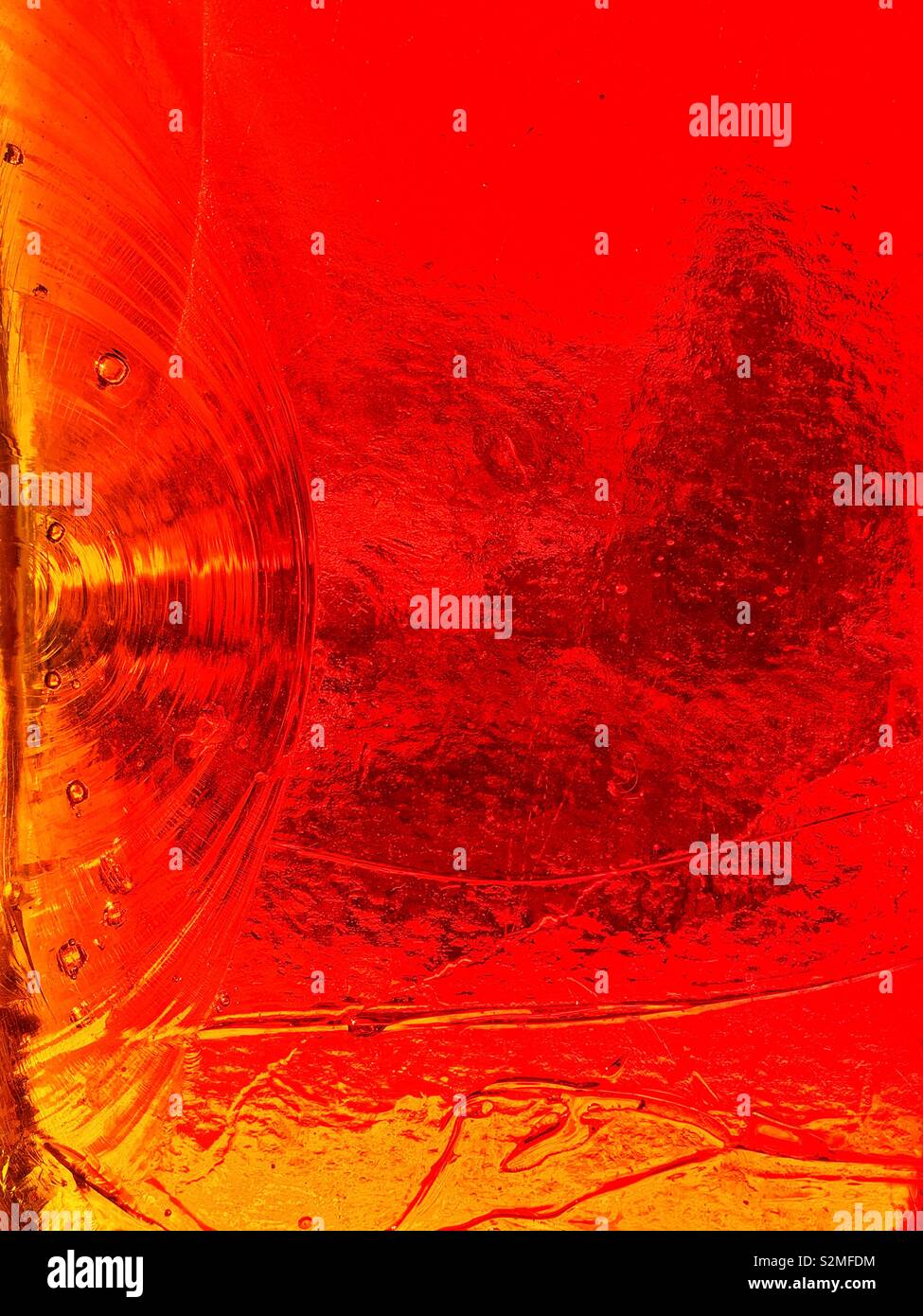 Decorative brightly colored red and orange stained textured translucent ...