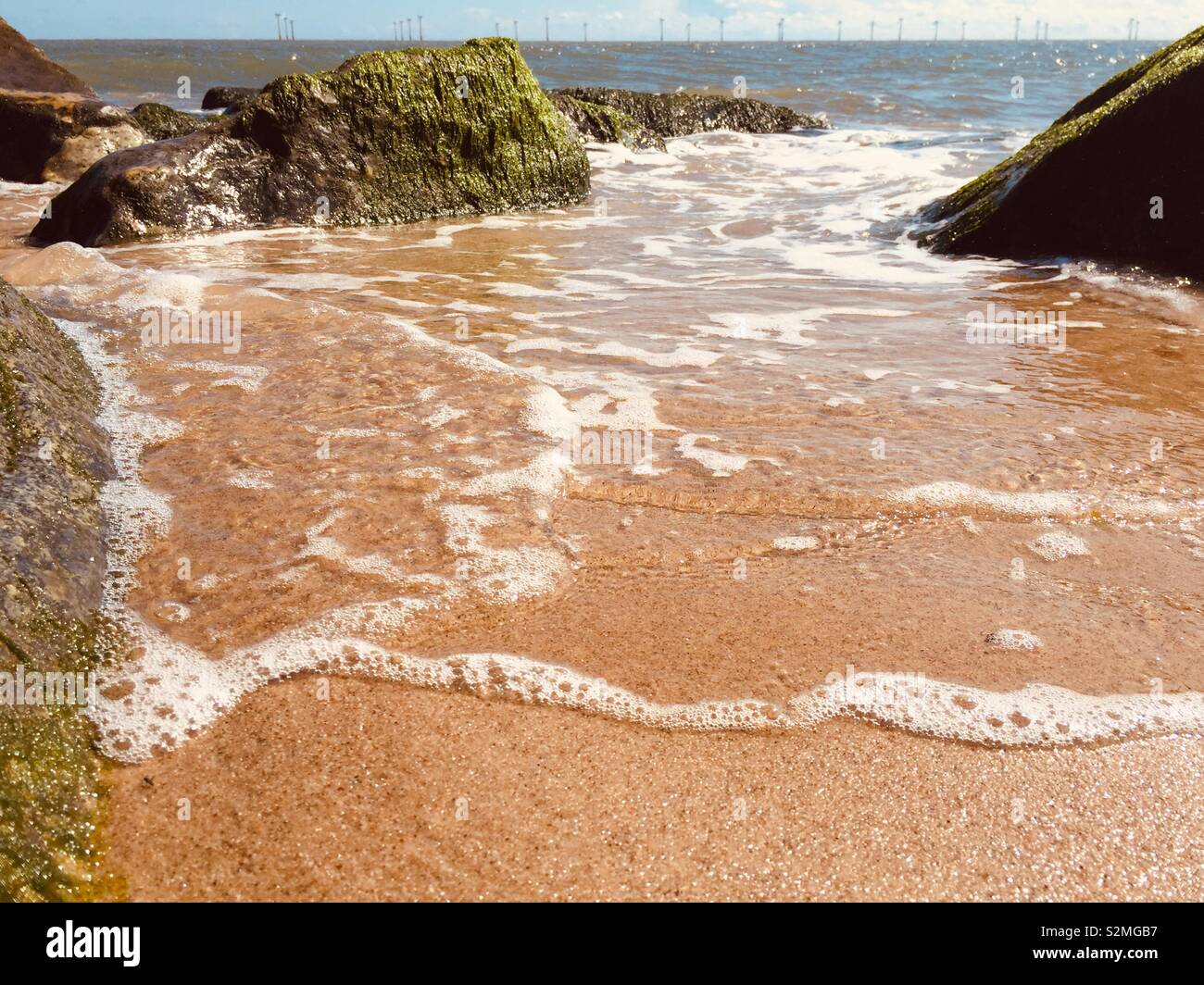 Tide rolling in Stock Photo - Alamy