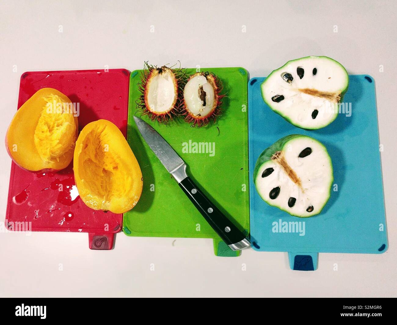 Fruit preparation on colourful cutting boards Stock Photo - Alamy