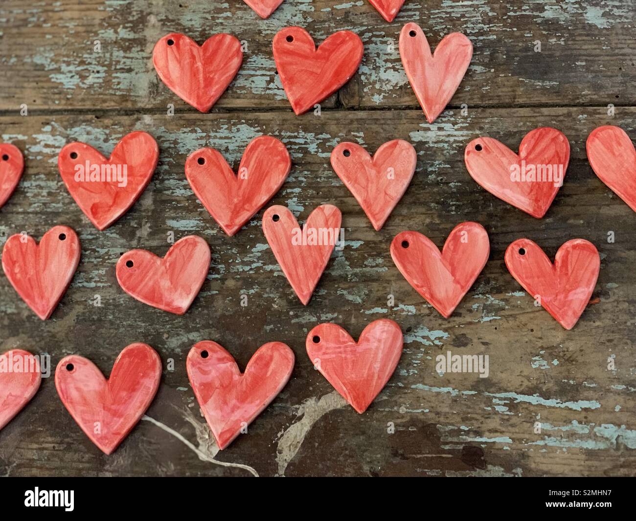 Ceramic red heart pendants Stock Photo - Alamy