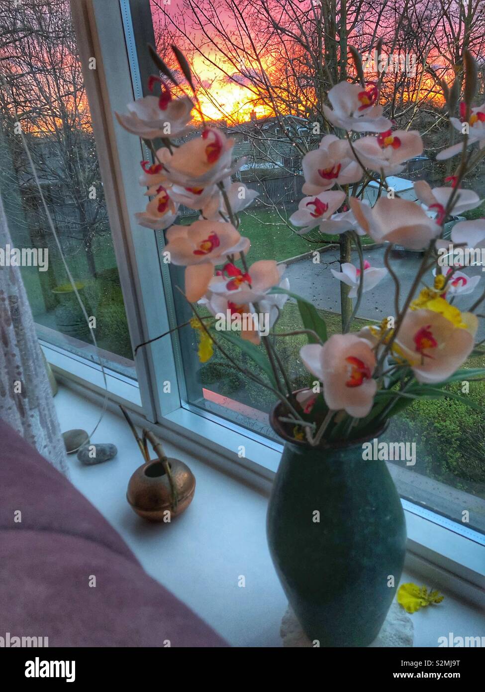 Looking at a beautiful sunset through a window Stock Photo - Alamy