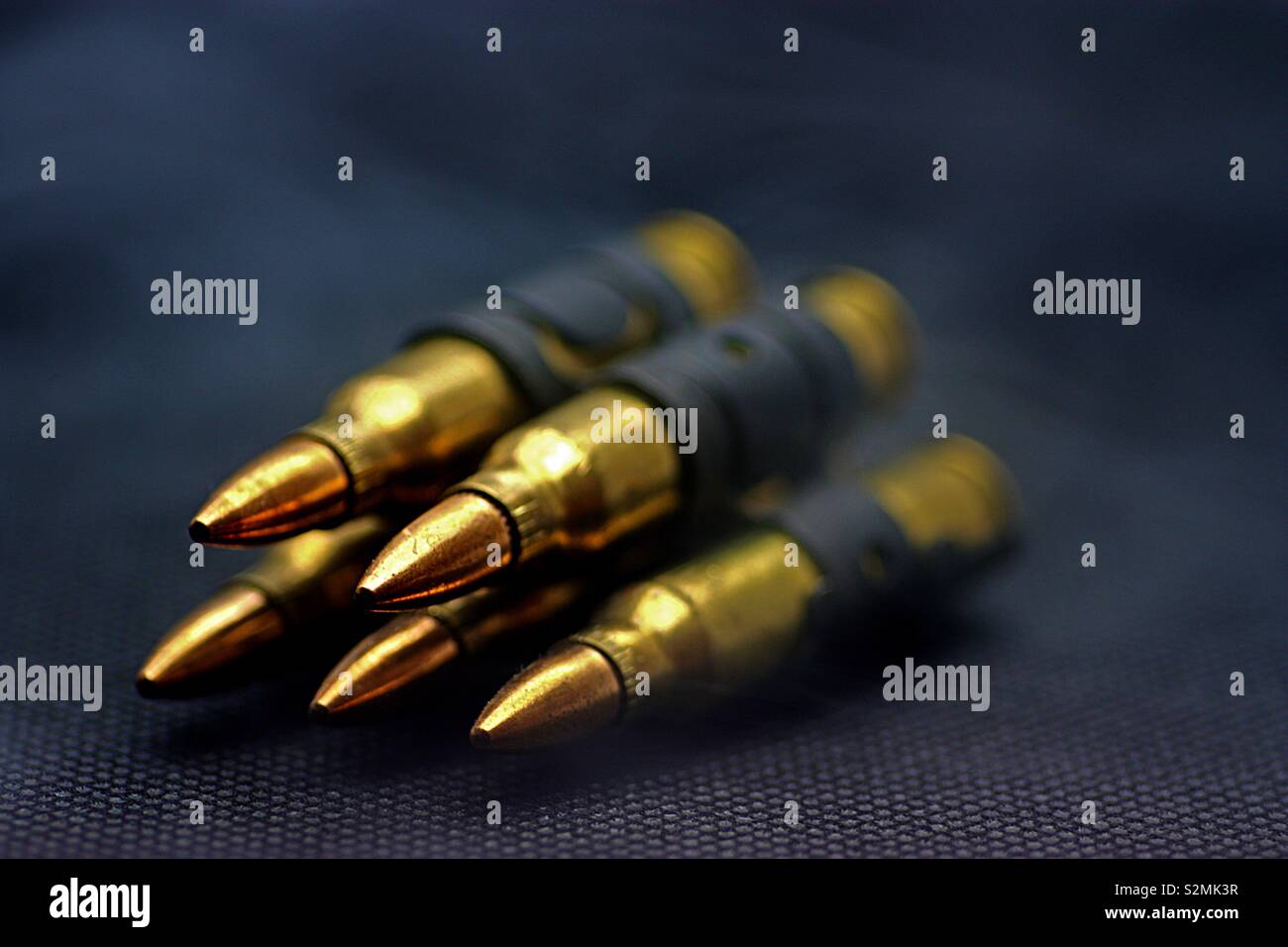 Close up stack of bullets against dark background Stock Photo - Alamy