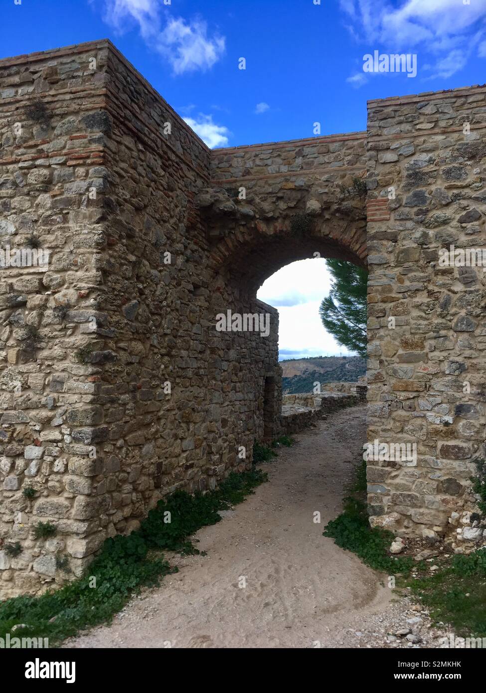 Historic gate, the rest of the ruins of old fortification of city Ronda ...