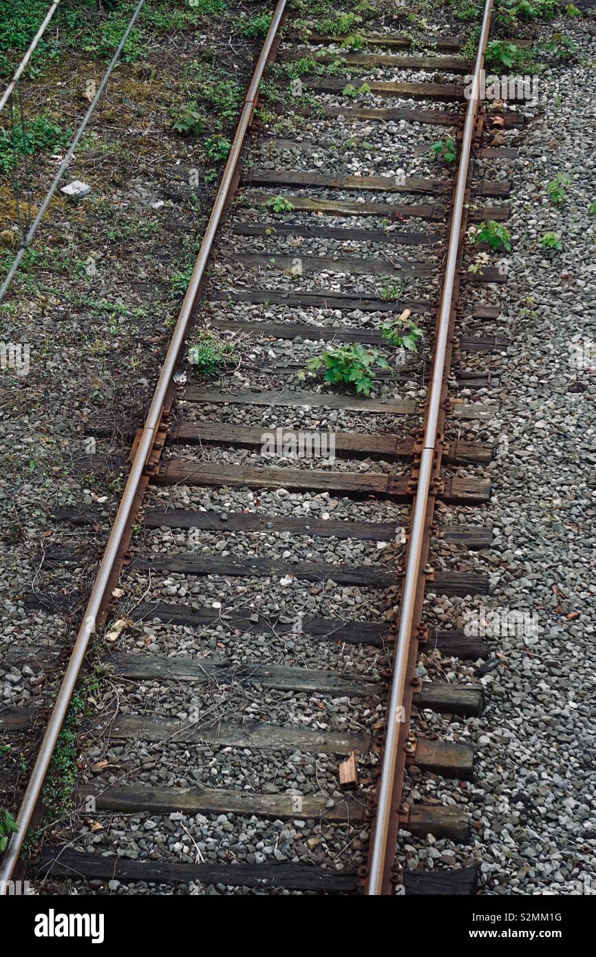 old train tracks in the station in the street Stock Photo - Alamy