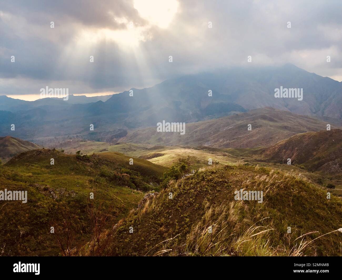 Sun rays over Mt. Iglit-Baco in San Jose, Mindoro, Philippines Stock ...