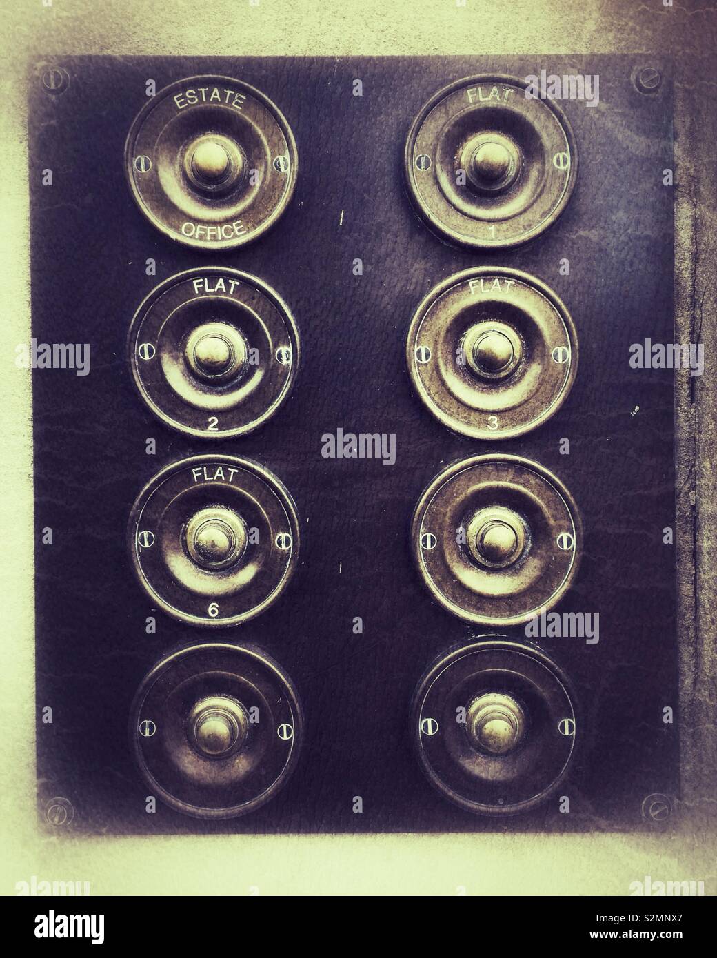 Panel of eight bell pushes by the front door of an old country house ...